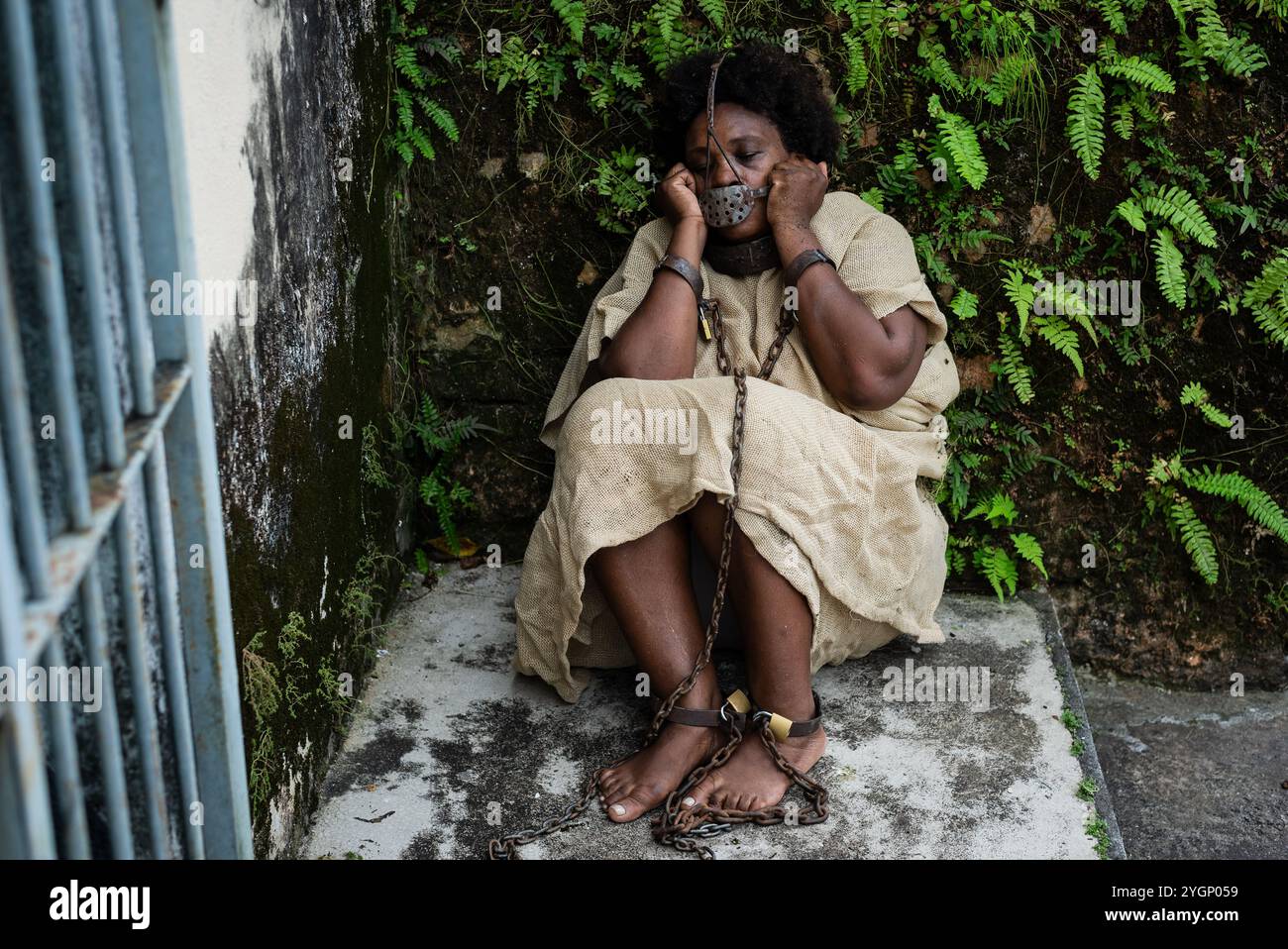Portrait of a woman dressed as a slave with an iron mask on her mouth ...