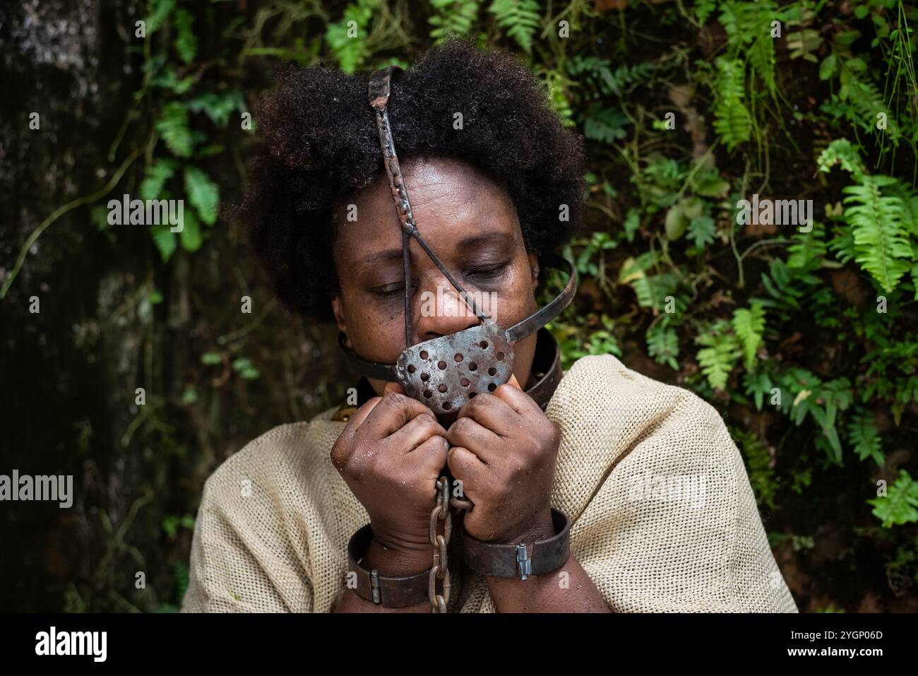 Portrait of a woman dressed as a slave with an iron mask on her mouth ...