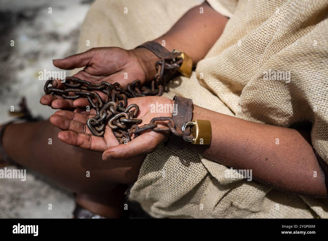 Portrait of a woman's hands in chains holding the chains. Slavery in Brazil. Representation of ...