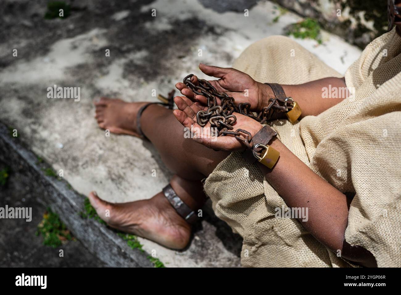 Portrait of a woman's hands in chains holding the chains. Slavery in ...