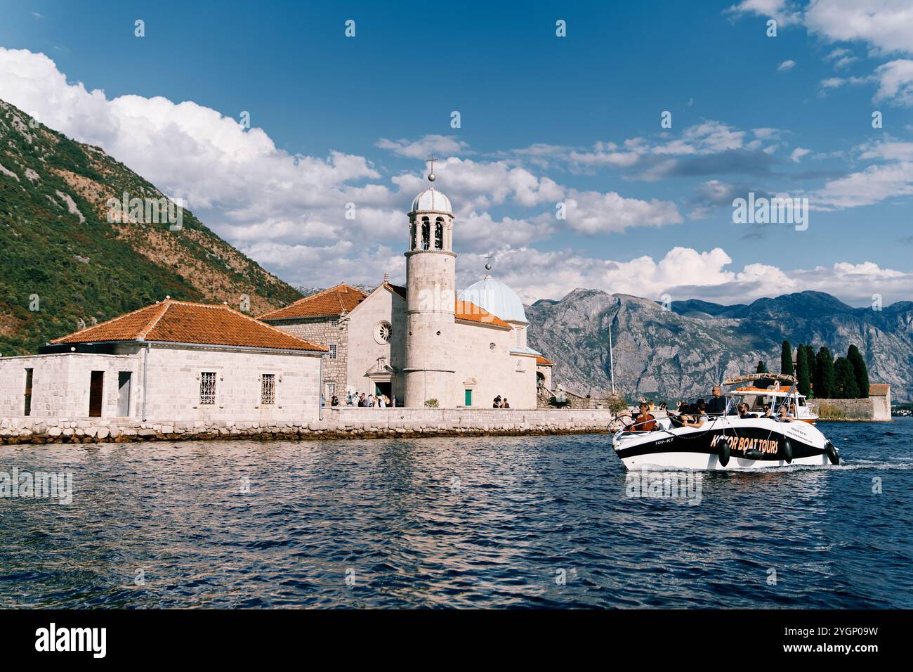 Yacht with tourists sails past the Church of Our Lady of the Rocks on ...