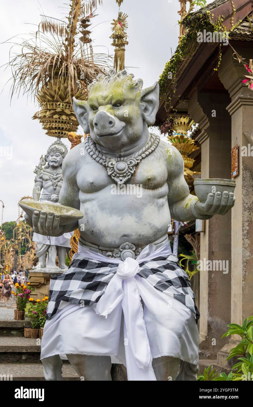 Statue with a pig's face. Traditional Balinese village of Penglipuran ...