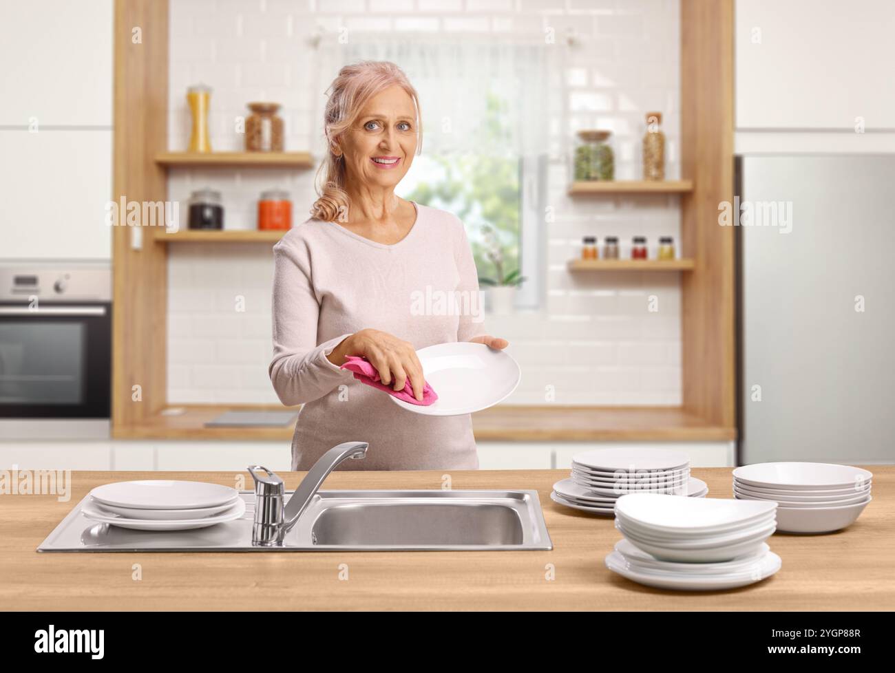 Housewife washing dishes in kitchen hi-res stock photography and images ...