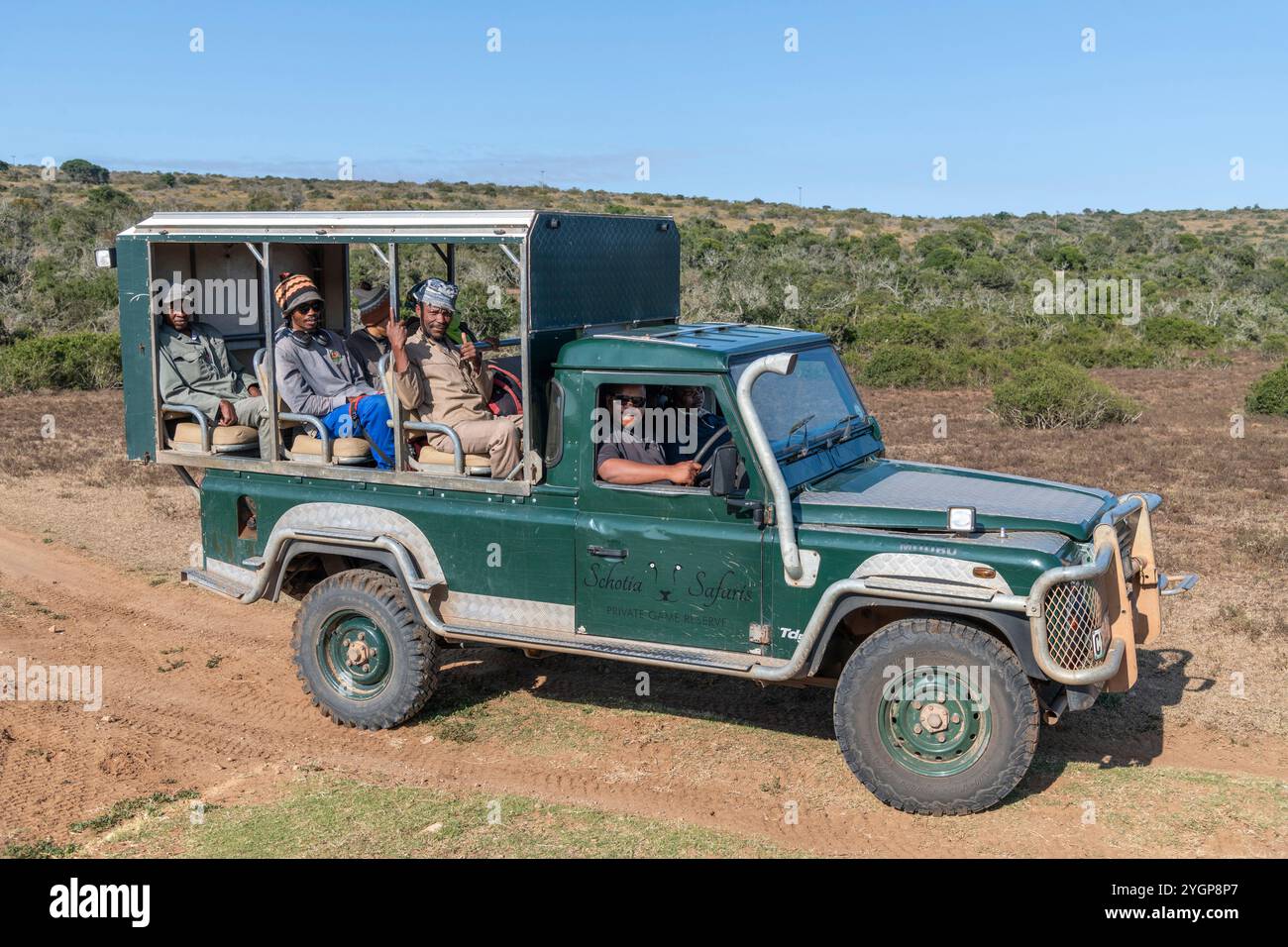 A view of a group of rangers / workers sitting in a safari jeep vehicle ...