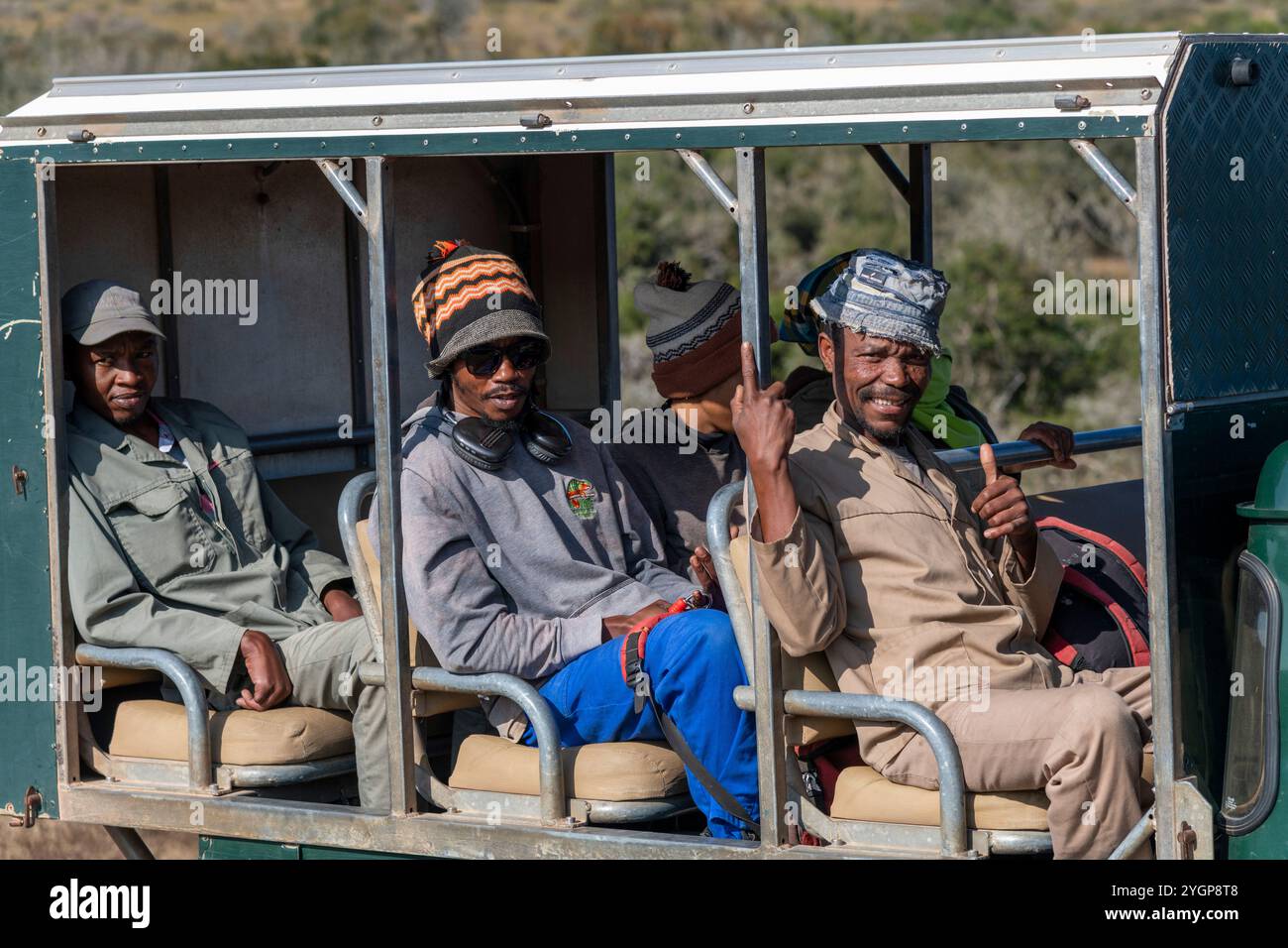 A view of a group of rangers / workers sitting in a safari jeep vehicle ...