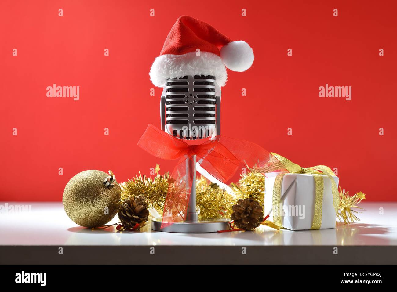 Retro microphone with Santa hat on white table with gifts and Christmas ...