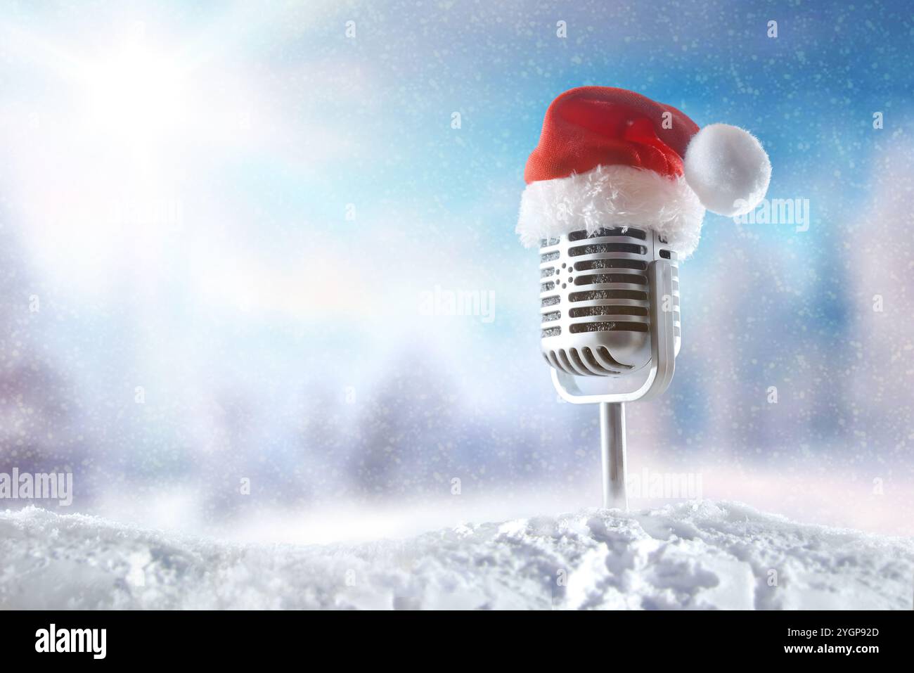 Vintage microphone with Santa hat and metal stand stuck on a pile of ...