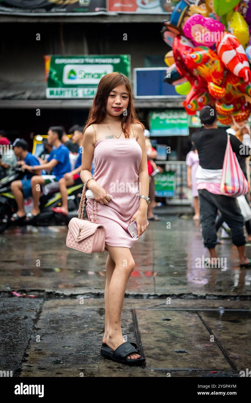 A beautiful young Filipino girl poses in the Binondo district of Manila ...