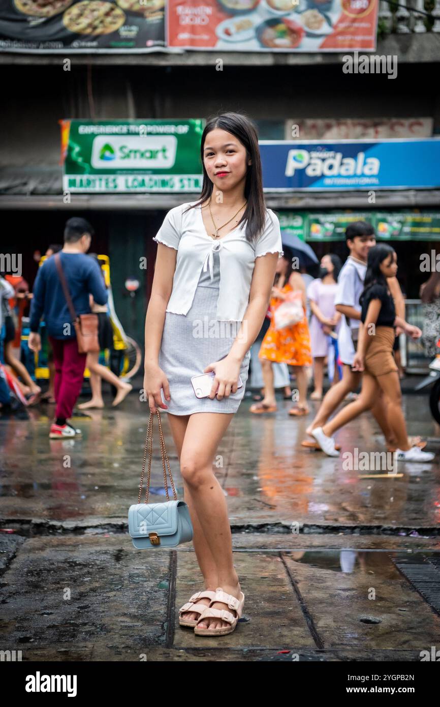 A beautiful young Filipino girl poses in the Binondo district of Manila ...