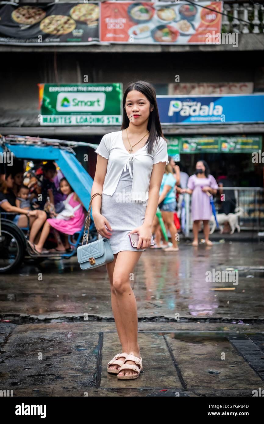 A beautiful young Filipino girl poses in the Binondo district of Manila ...