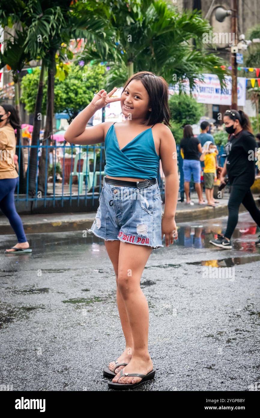 A young Filipino girl poses outside the Santo Nino de Tondo Church in ...