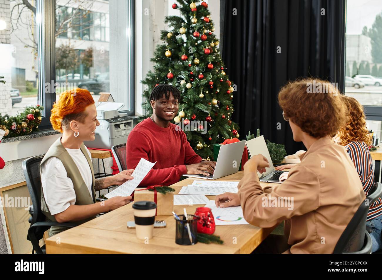 Coworkers share laughter and festive cheer while enjoying Christmas ...