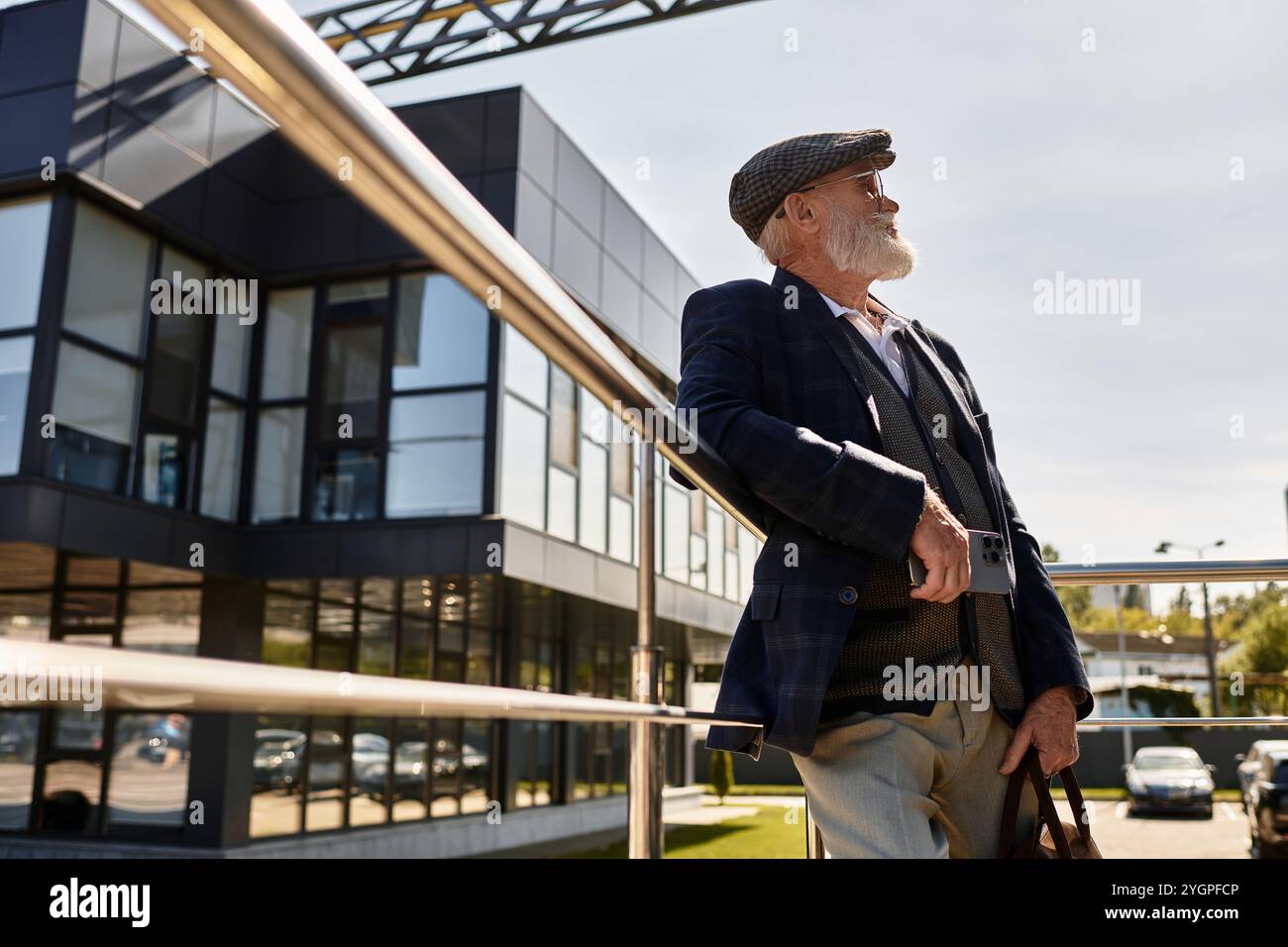 A dapper senior man with a beard stands confidently in smart casual ...