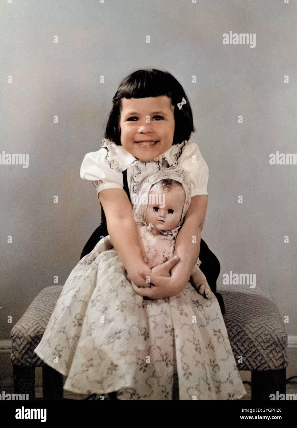 Three year old toddler girl holding her new baby doll, December 24 ...