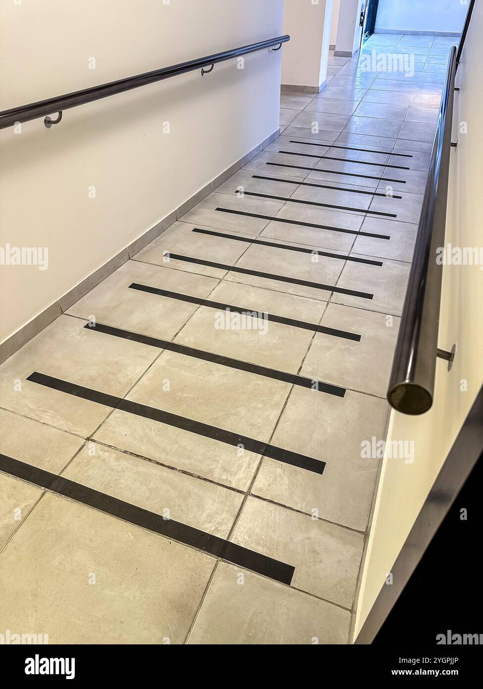 Corridor floor with anti-slip strip and handrail for elderly safety ...