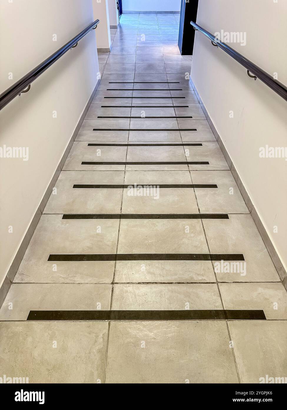 Corridor floor with anti-slip strip and handrail for elderly safety ...