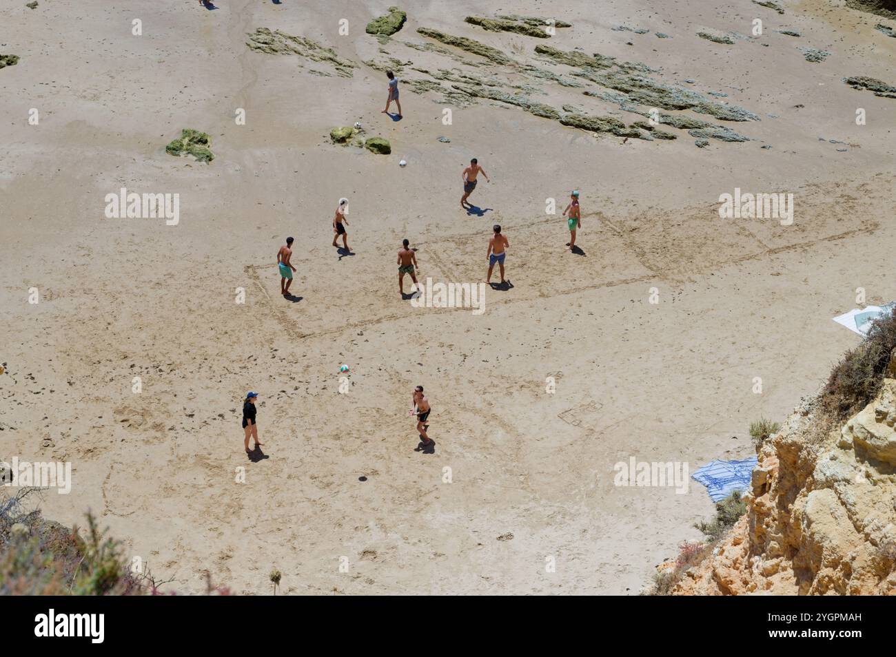 Aerial view of people playing soccer on the sandy beach praia da rocha ...