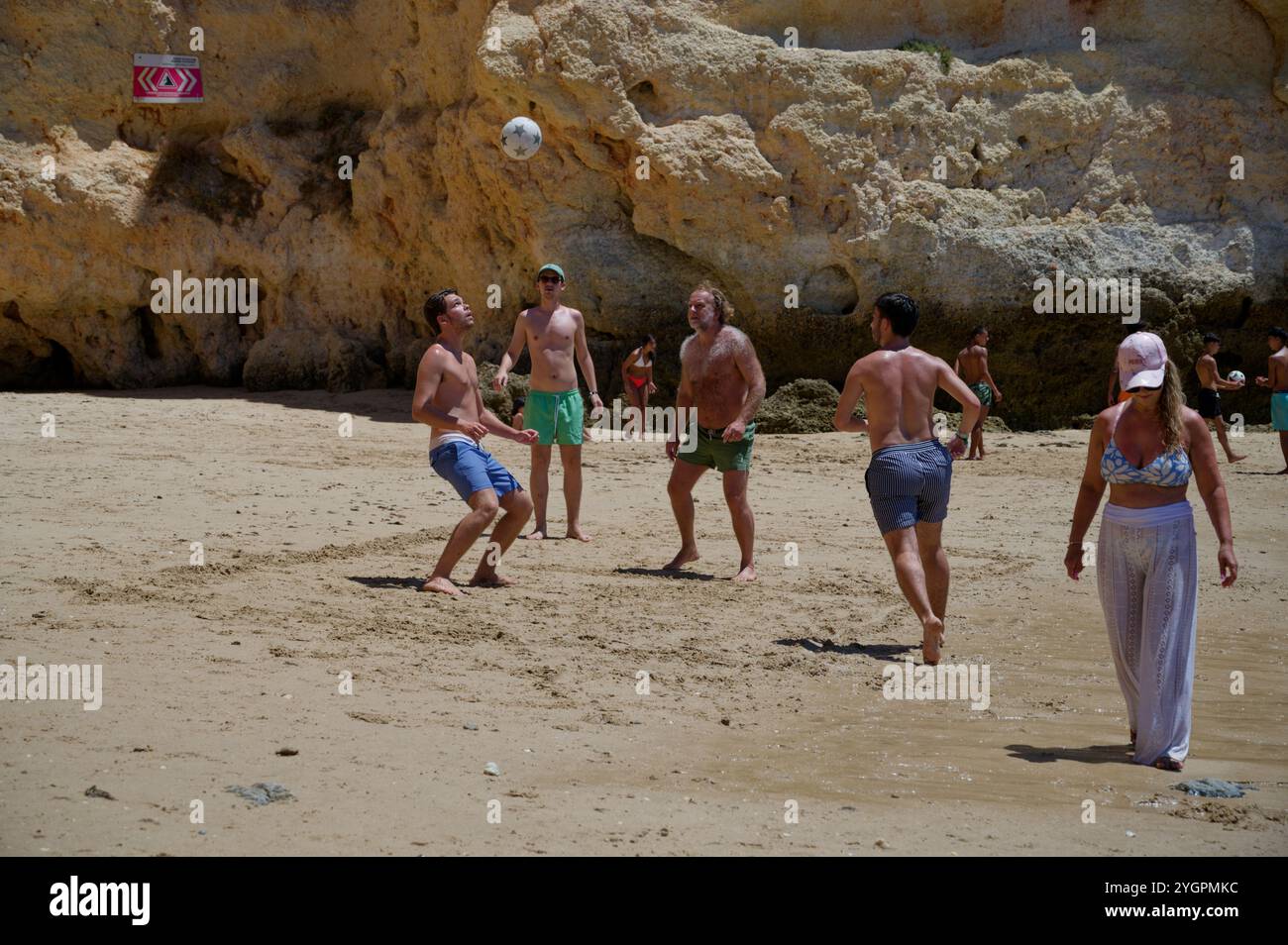 Beachgoers enjoying a friendly game of soccer on the sandy shores of ...