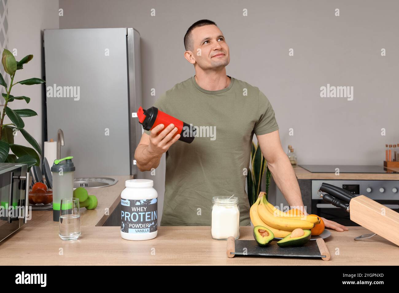 Muscular man preparing protein cocktail hi-res stock photography and ...