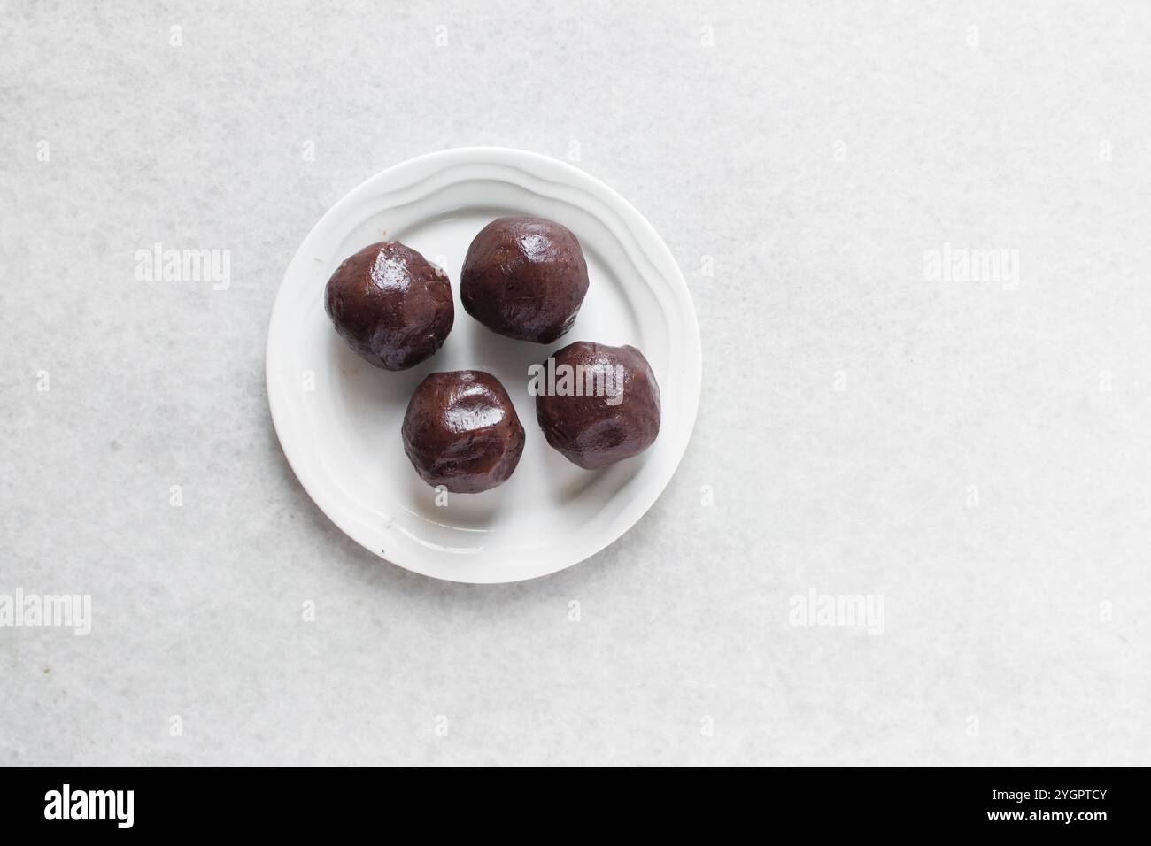 Overhead view of red bean paste balls in a white bowl, top view of ...