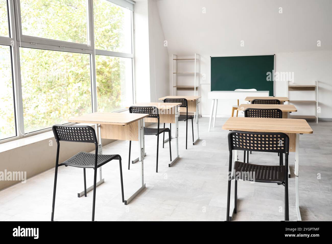 Interior of empty classroom with blackboard and desks Stock Photo - Alamy