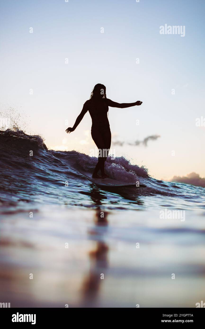 Lone female surfer on beach hi-res stock photography and images - Alamy