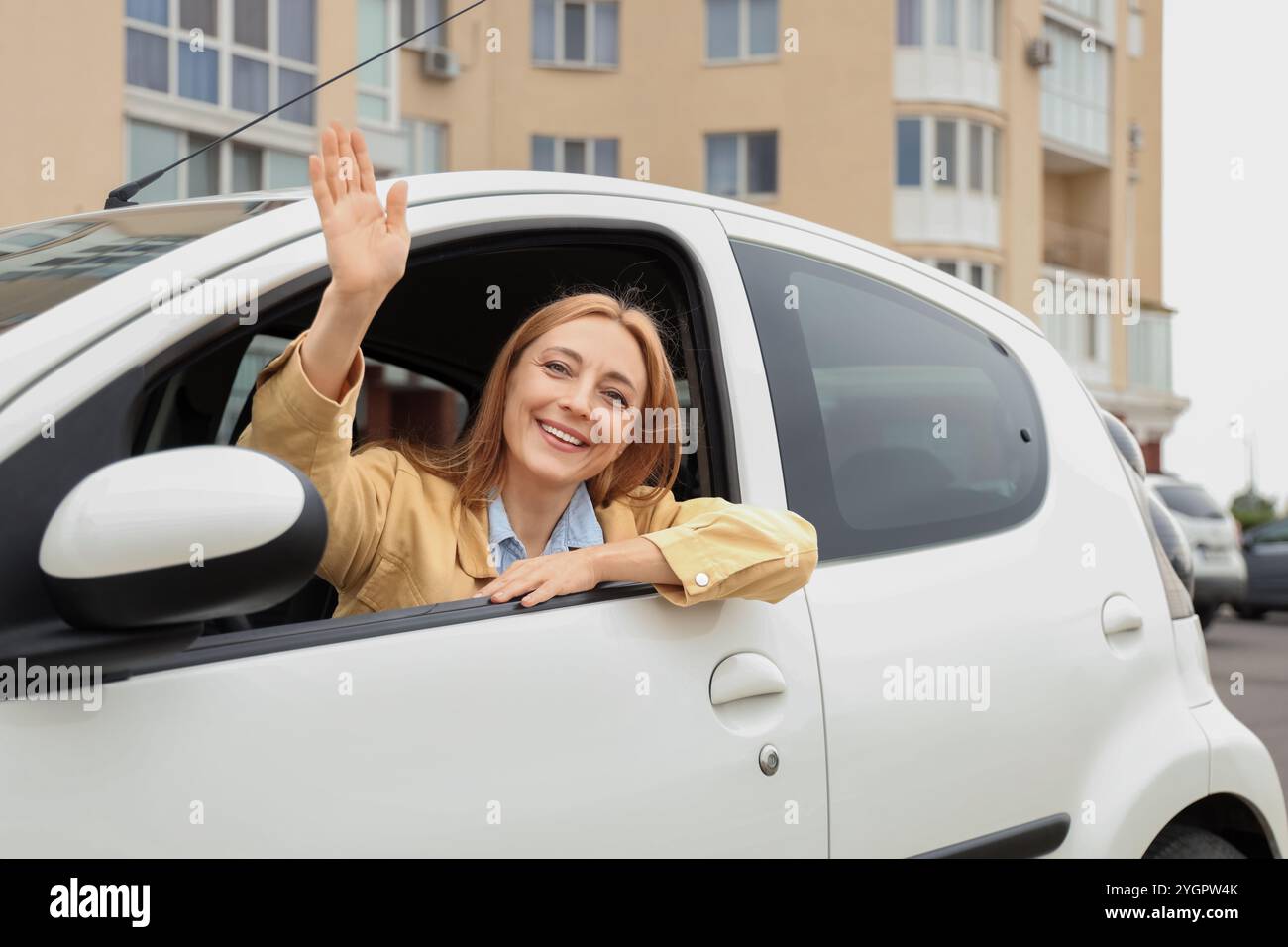 Female driver waving hand hi-res stock photography and images - Alamy