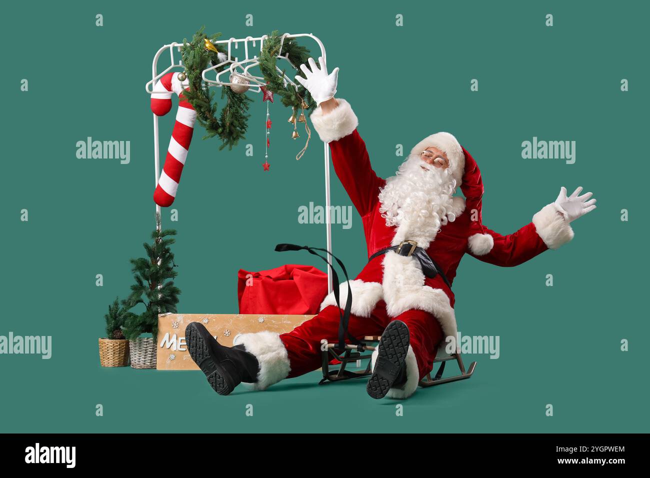 Santa Claus sitting on sledge near rack with different decorations ...