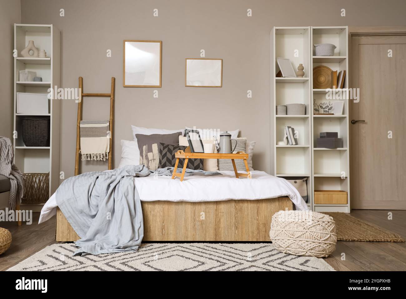 Interior of stylish bedroom with ladder and shelf units Stock Photo - Alamy