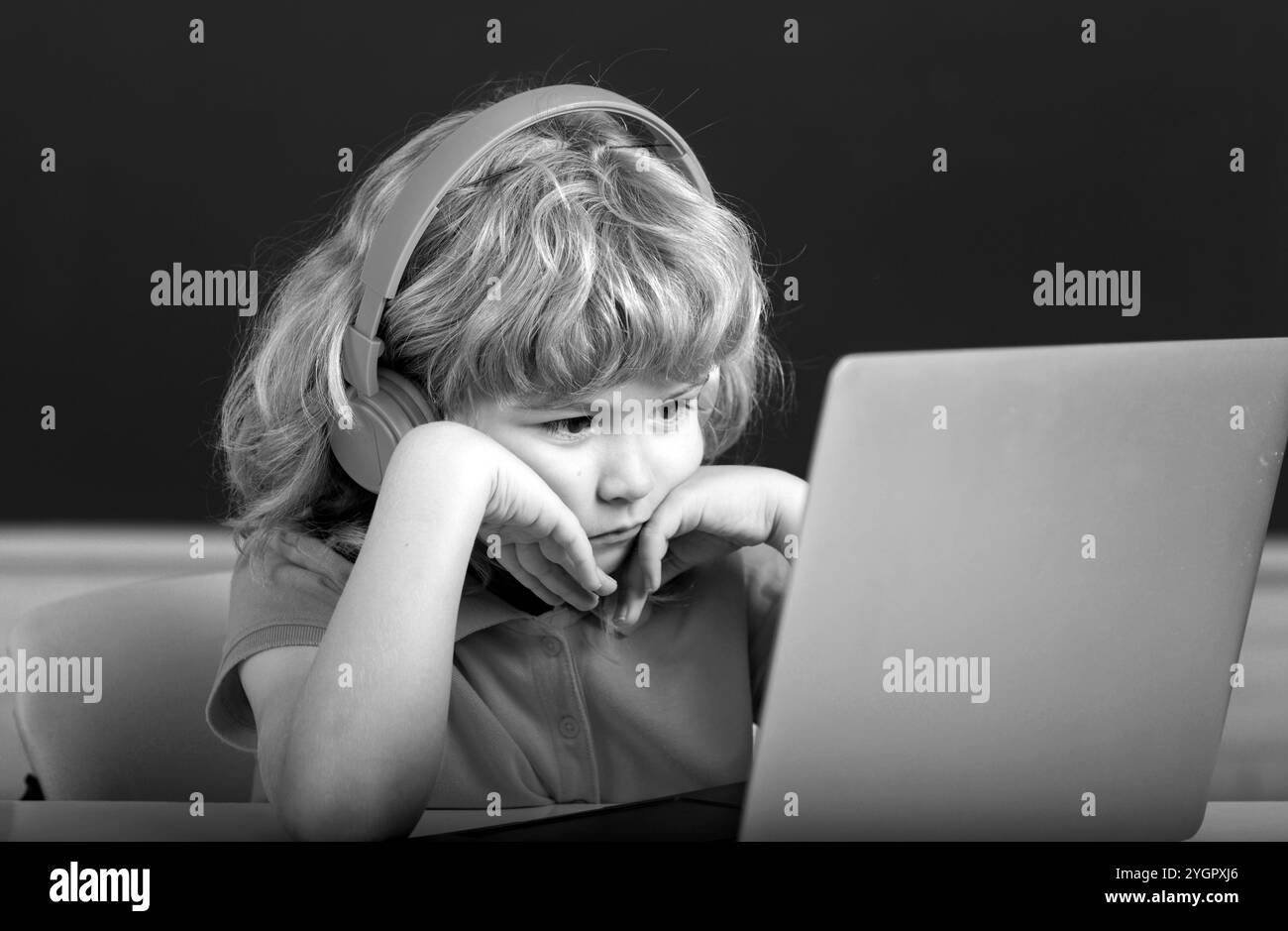 Serious boy student learning online in class. Kid study online video ...