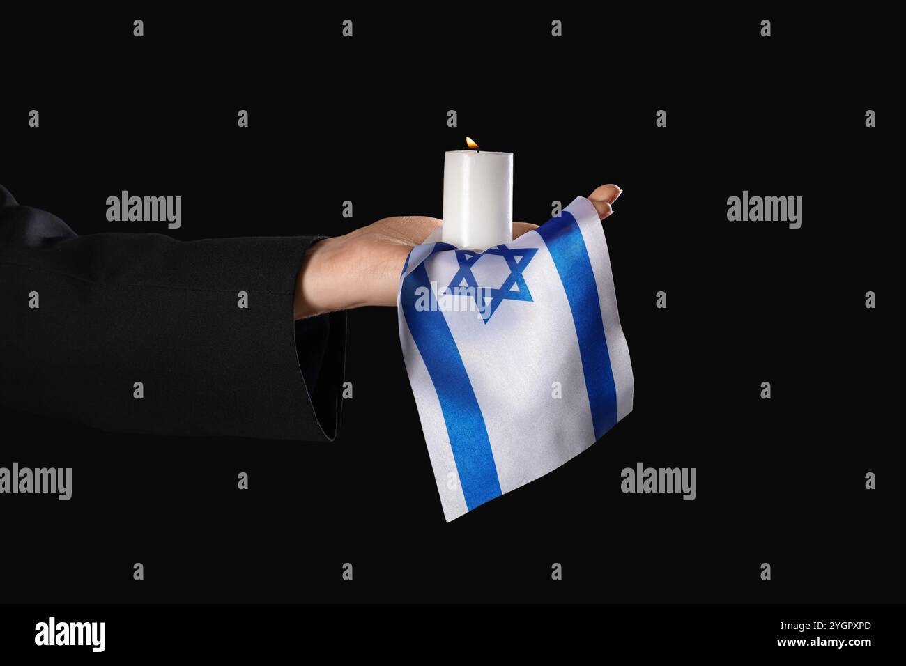 Jewish woman with burning candle and flag of Israel on black background ...