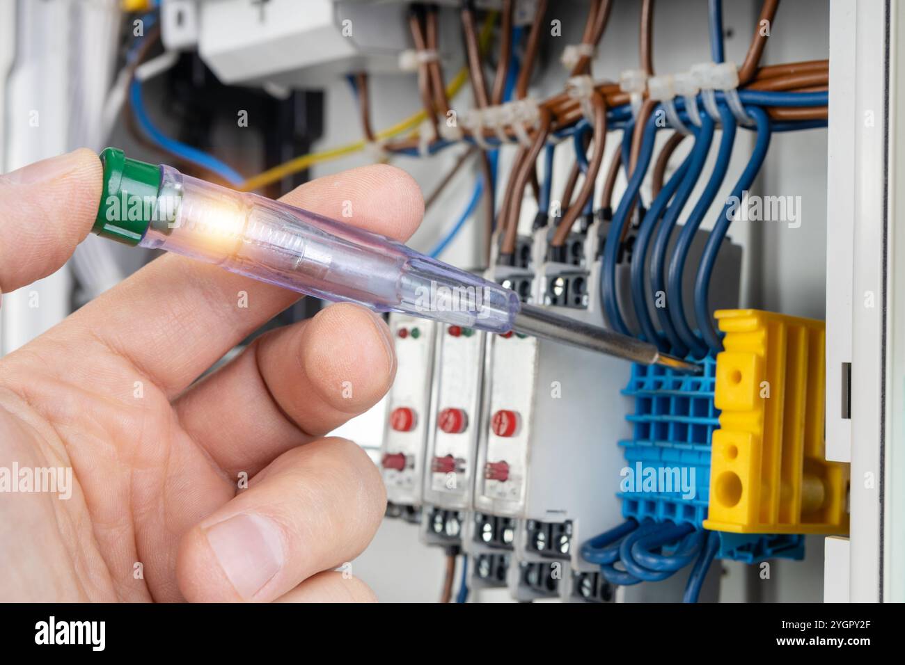 Hand Holding Voltage Tester Near Electrical Wiring Stock Photo - Alamy