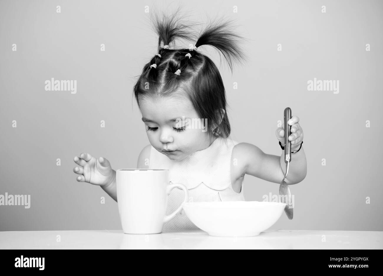 Baby child eating food. Babys first meal. The child eats on his own ...