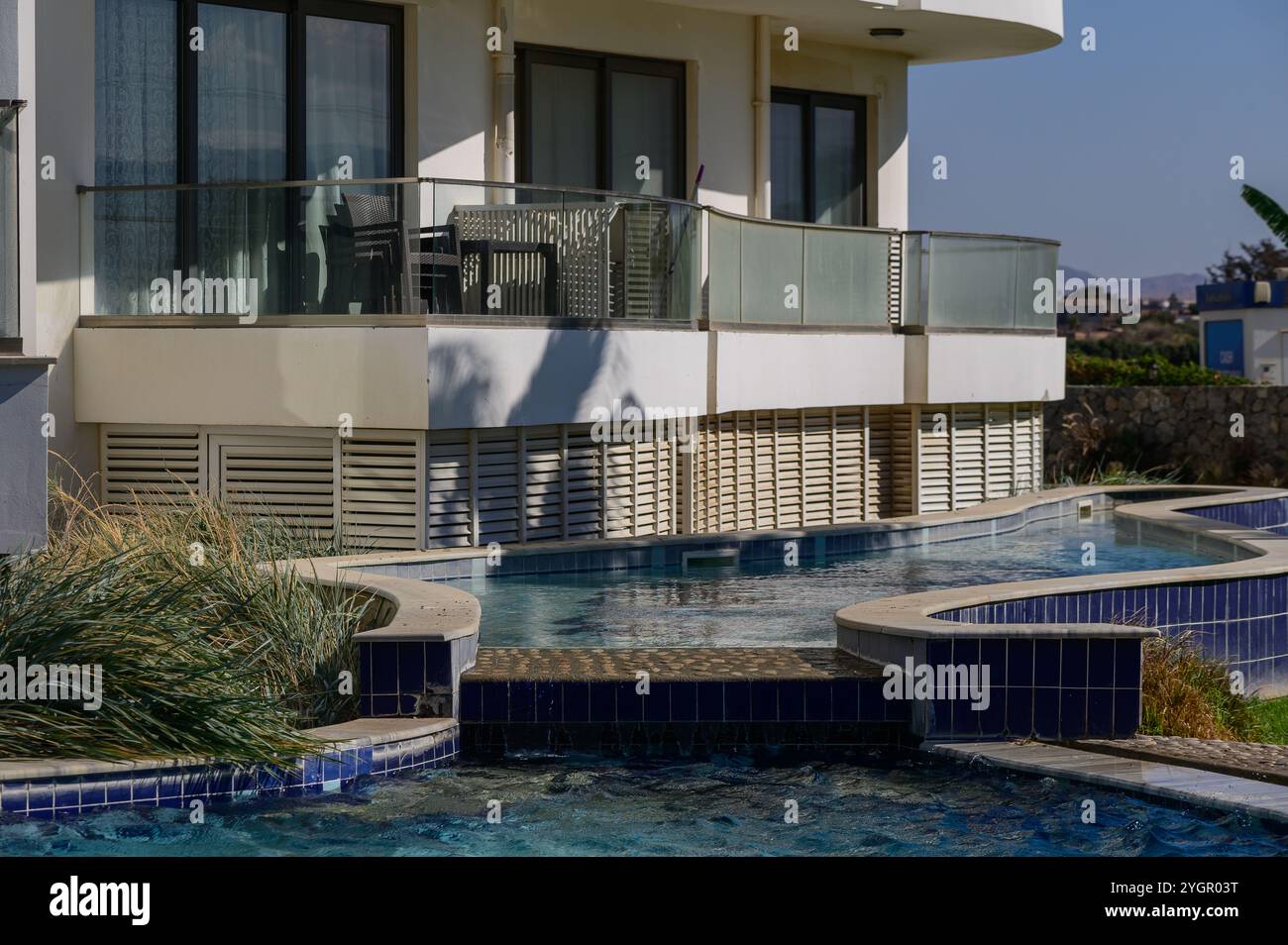 A sleek poolside area featuring contemporary architecture and relaxing ...