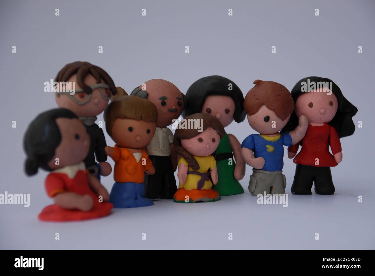 3D rendering in stylized clay of a group of people of different ages ...