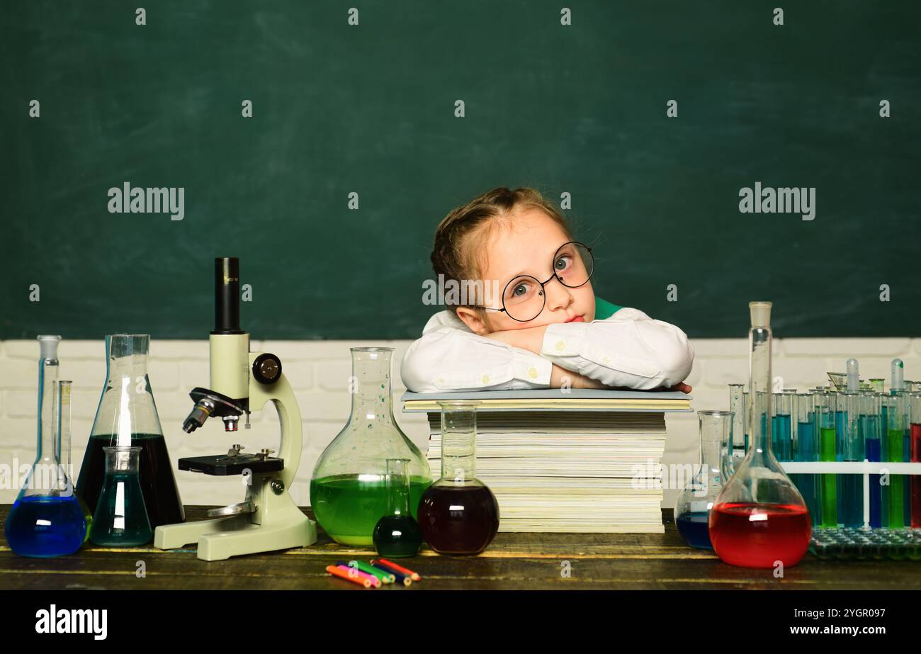 Back to school and home schooling. Little kids scientist earning chemistry in school lab. Kid ...