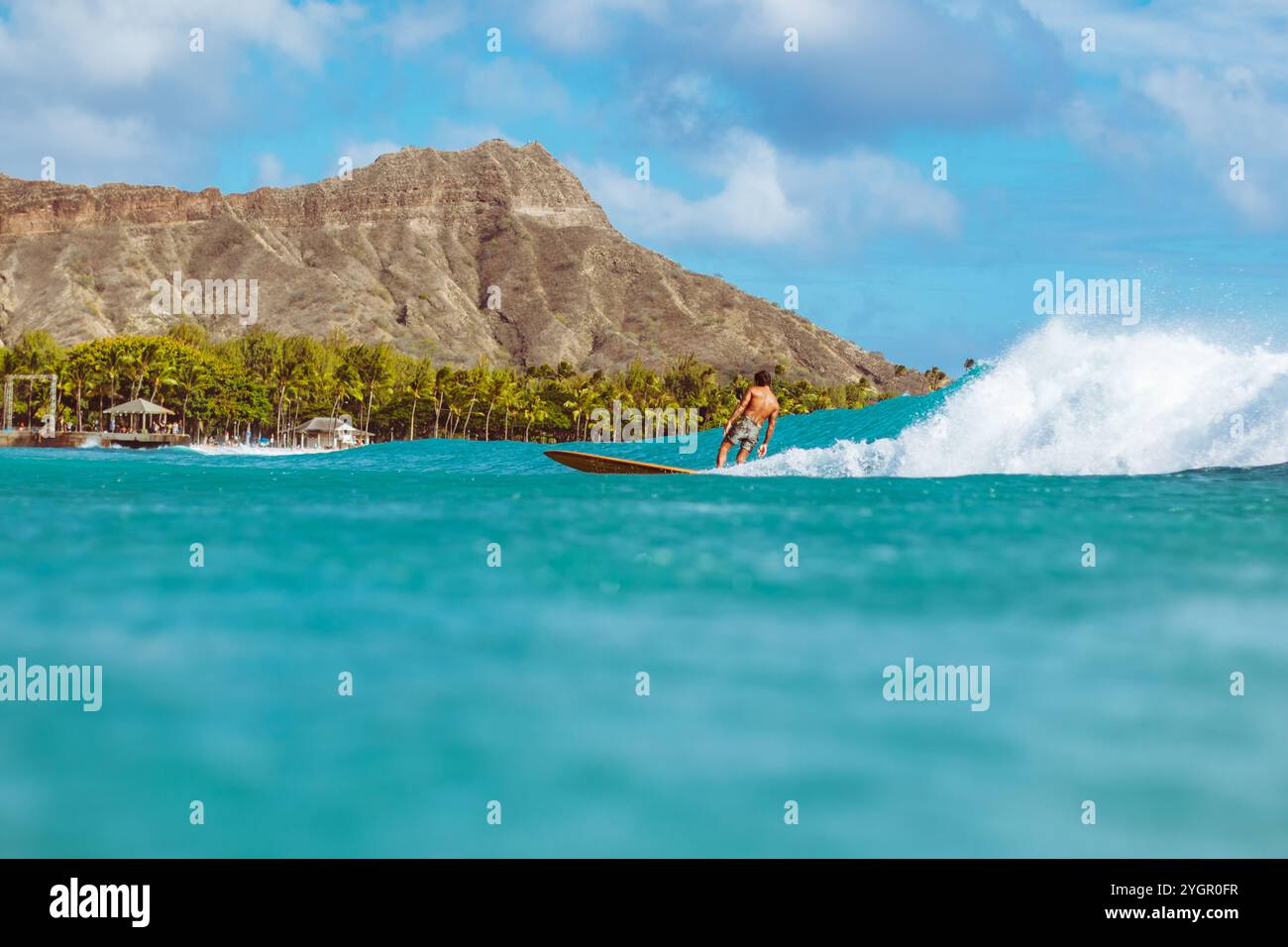 Arthur "Toots" Anchinges rides the iconic waves at Queens Beach Stock ...