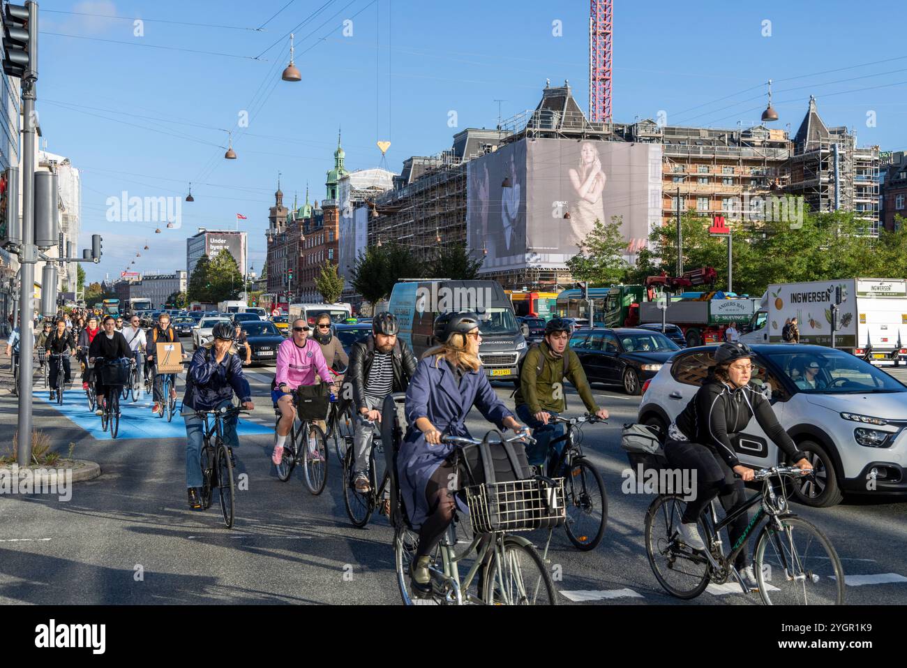 Men and women riding their bicycles through Copenhagen city centre in a ...