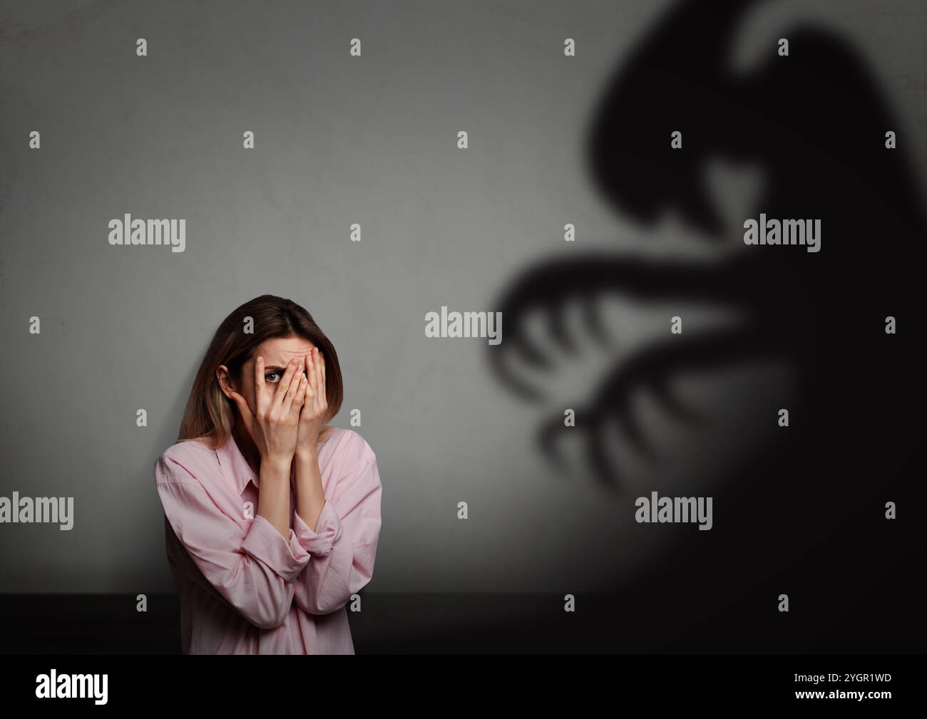 Woman scared by monster. Scary shadow in room Stock Photo - Alamy