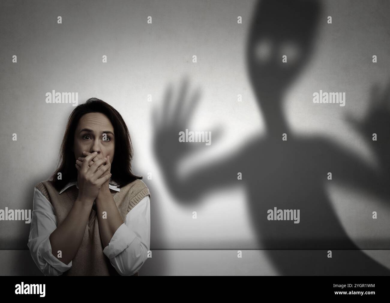Woman scared by monster. Scary shadow in room Stock Photo - Alamy