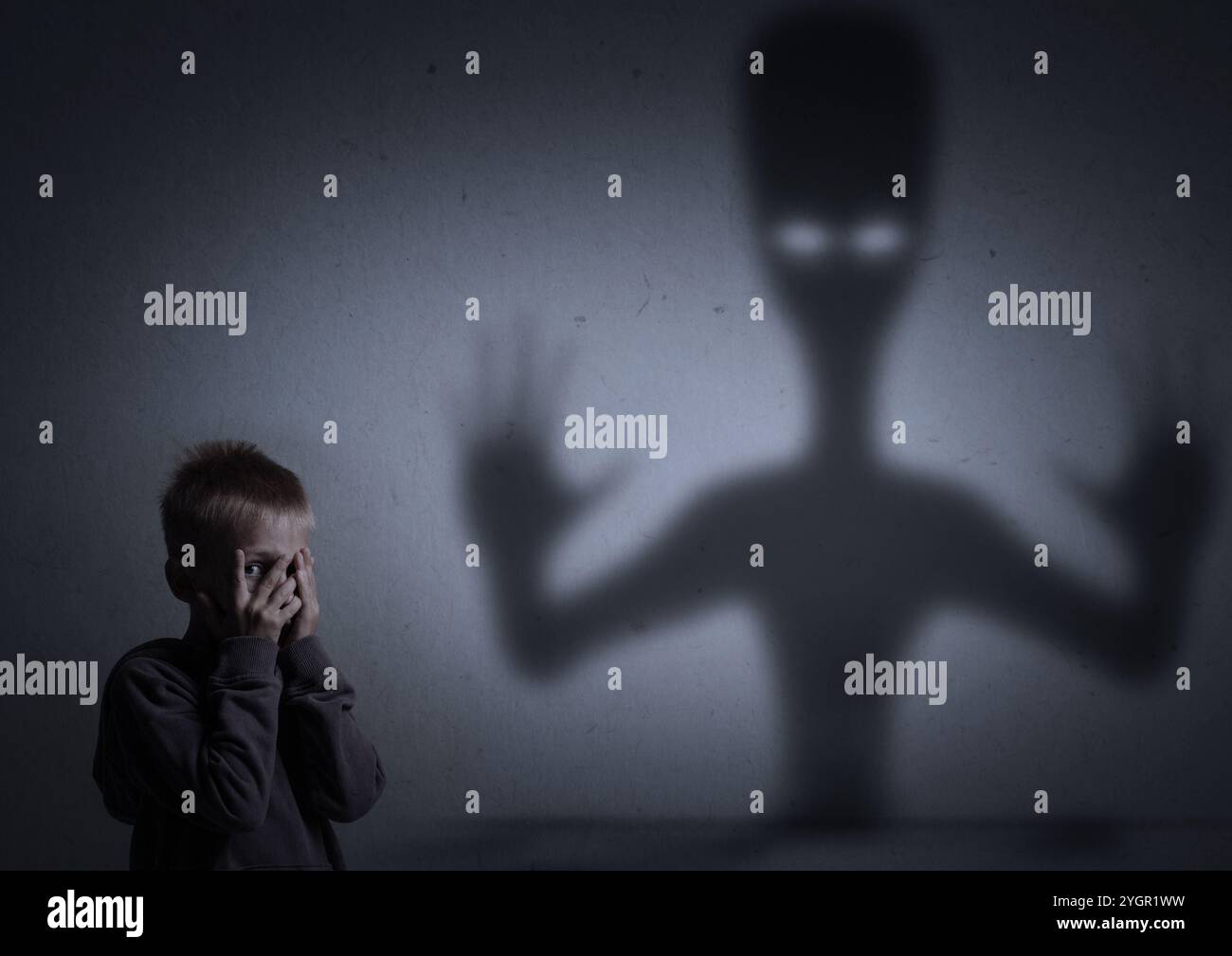Little kid scared by monster. Spooky shadow on grey wall Stock Photo ...