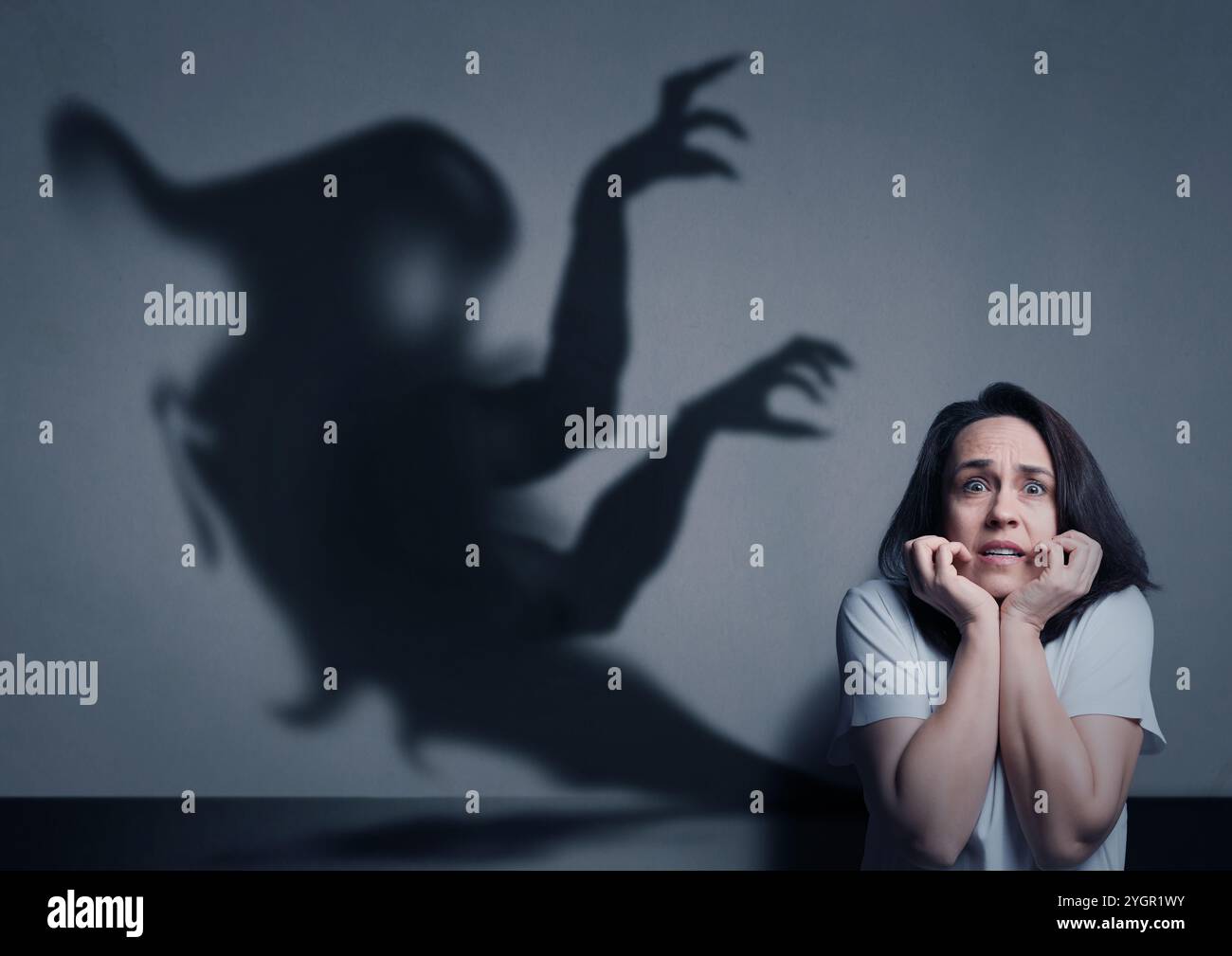 Woman scared by monster. Scary shadow in room Stock Photo - Alamy