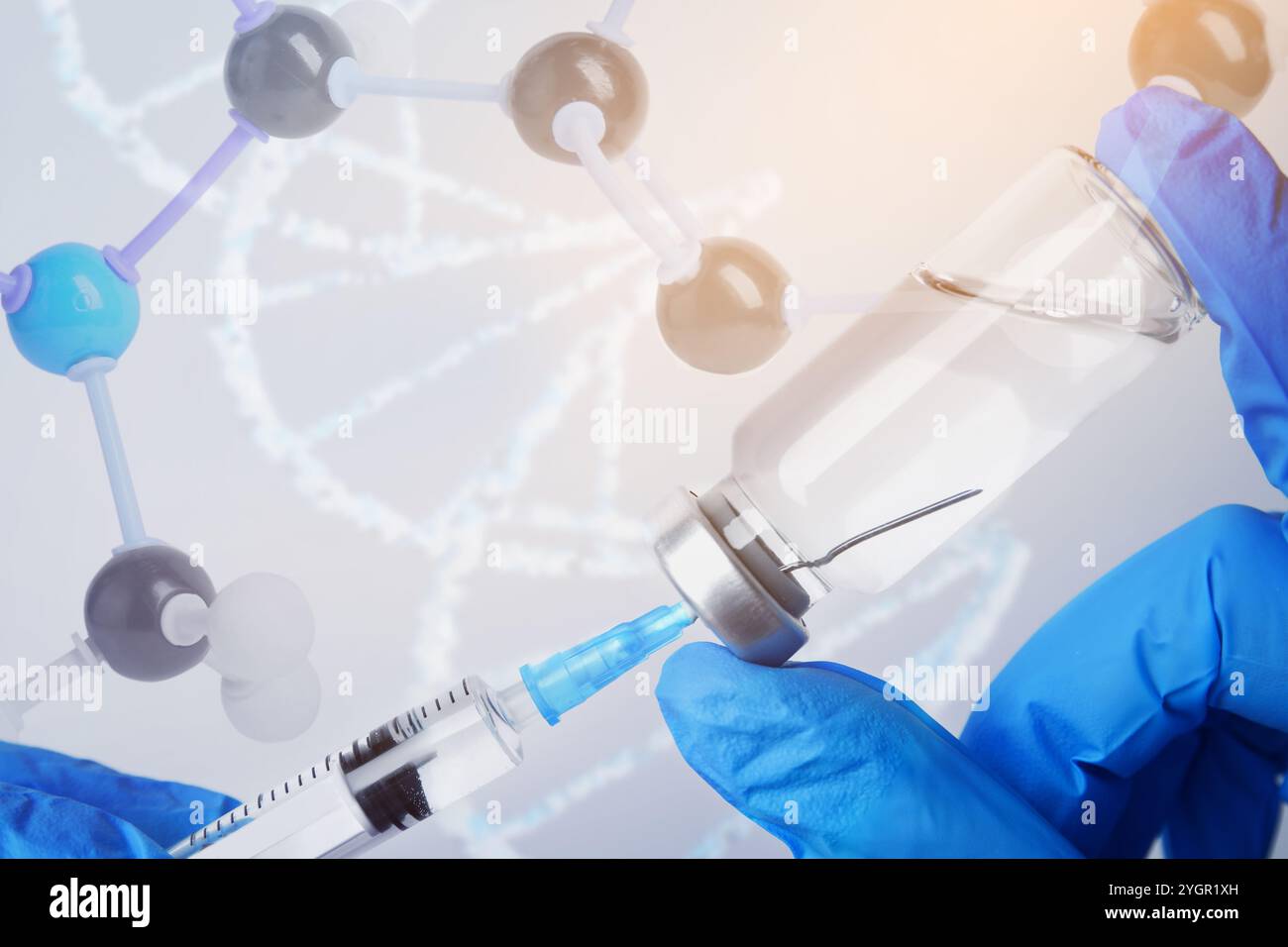 Doctor filling syringe with medication, closeup. Light background with ...