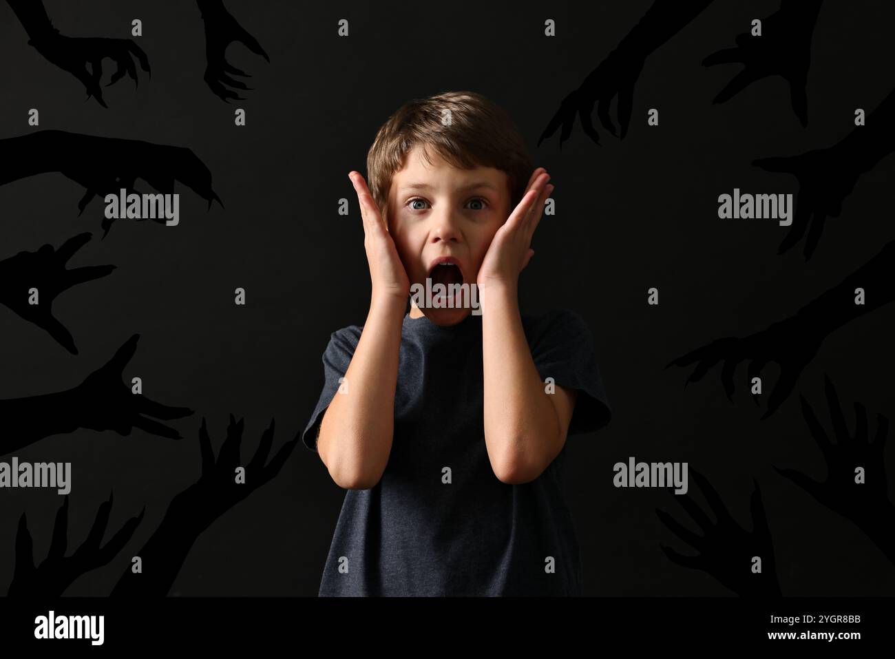 Teraphobia - fear of monsters. Scared boy screaming on black background ...