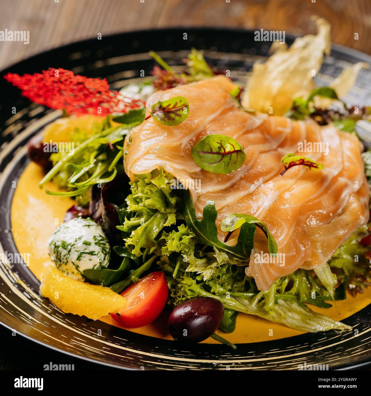 Top view of a gourmet salad with smoked salmon, vibrant greens, and ...