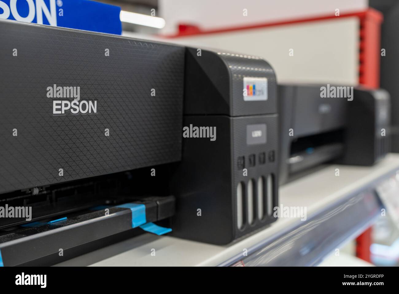 Epson logo on a printer close-up. Epson printer on a shelf in an ...