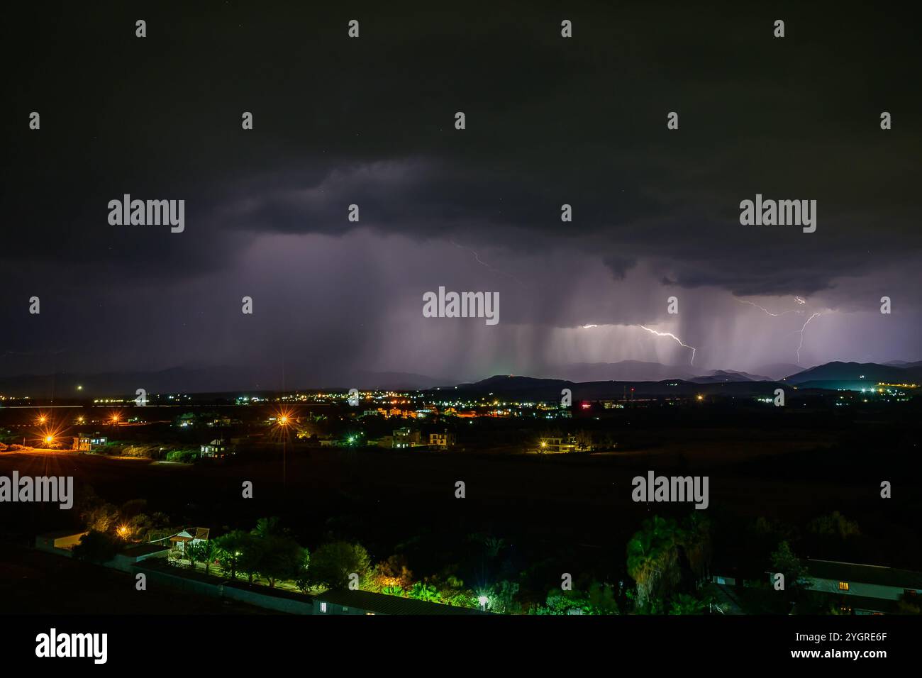 Brilliant flashes of lightning break the night as rain cascades down on ...