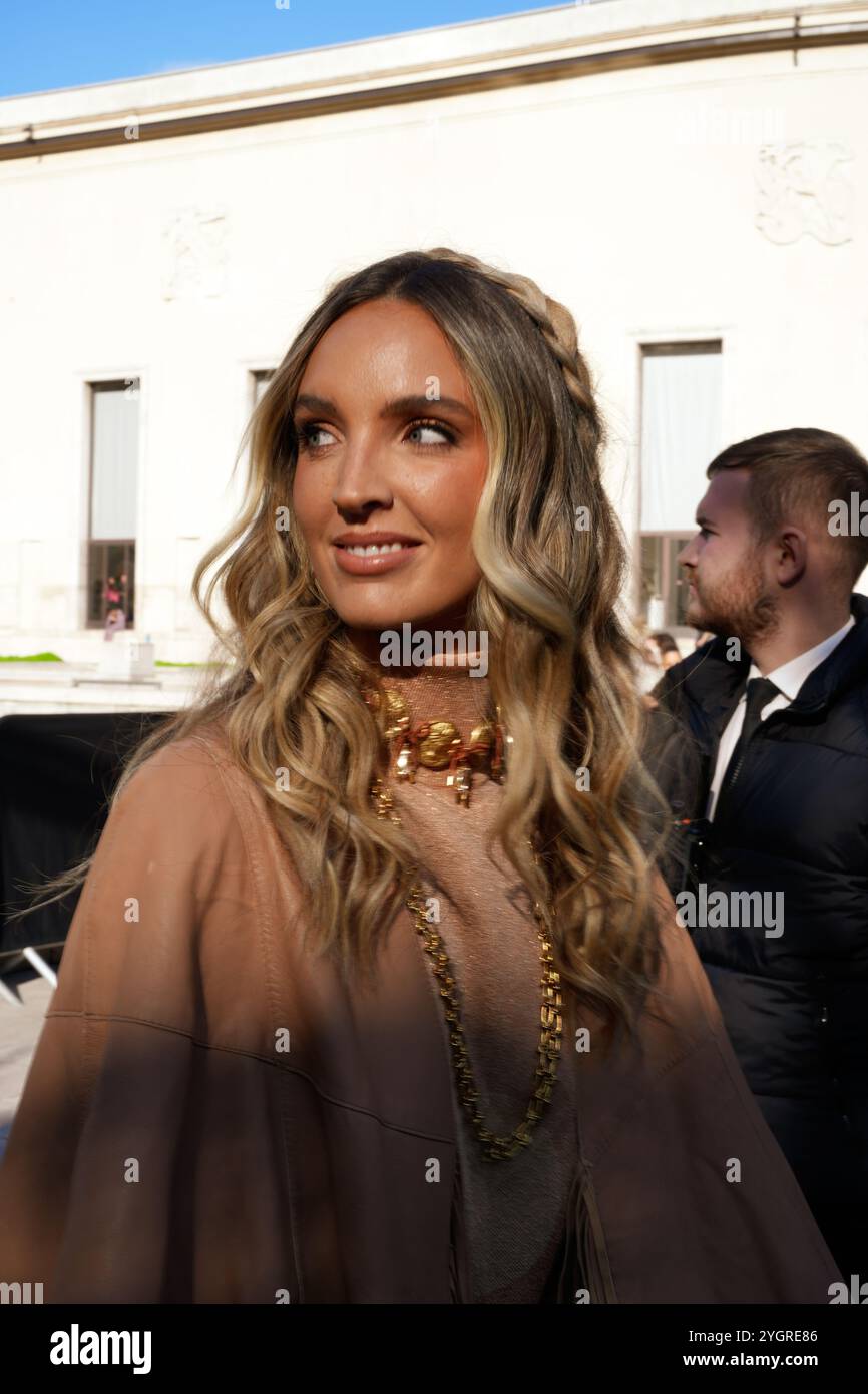 Cris Mata wearing turtle neck sweater, a plaid skirt, wrapped sweater ...