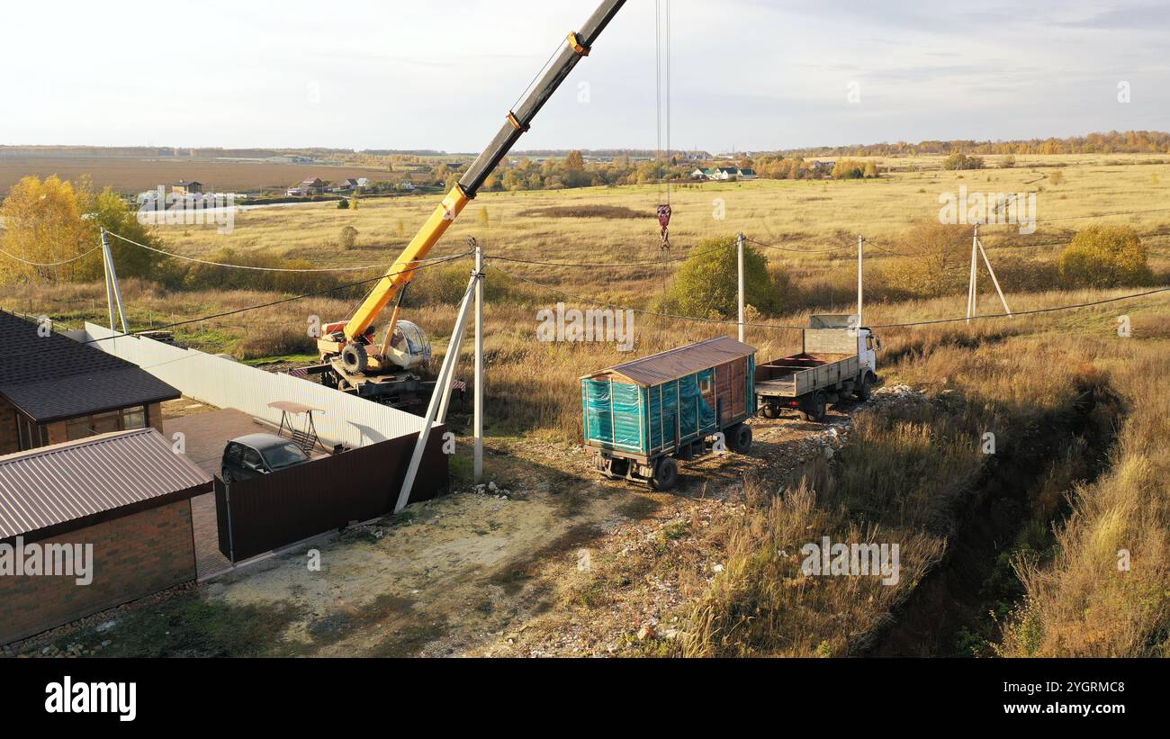 Unloading using a crane. The crane is working, loading into the truck ...