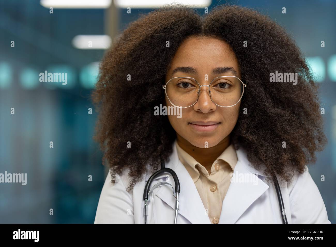 Confident African American woman doctor in white coat with stethoscope ...
